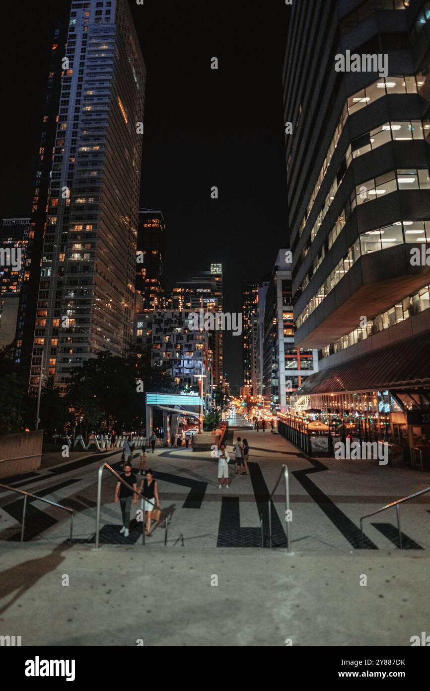 View down street outside the CN Tower at night in Toronto, Ontario ...