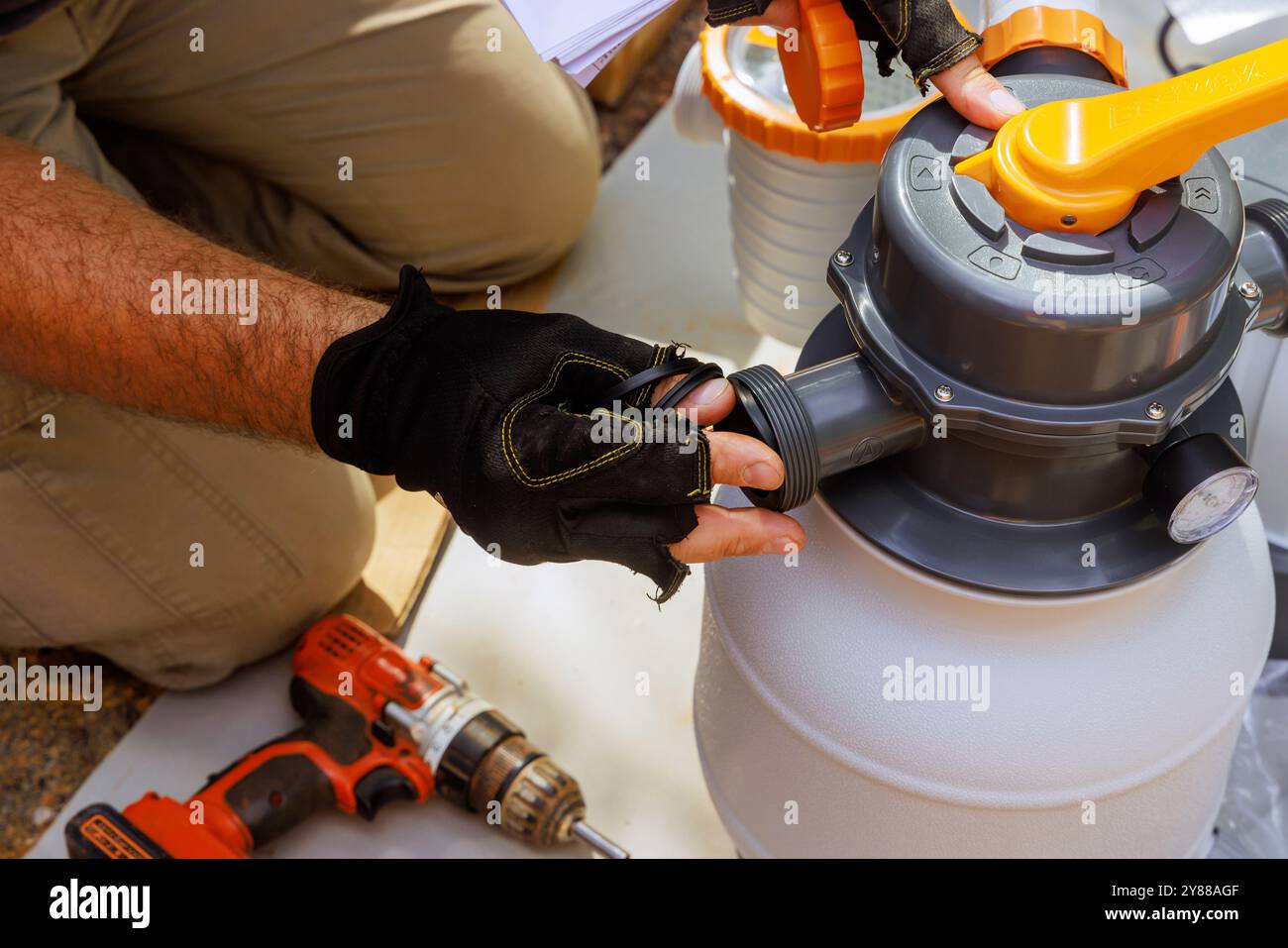 Assembling sand filter system tank equipment used to clean swimming ...