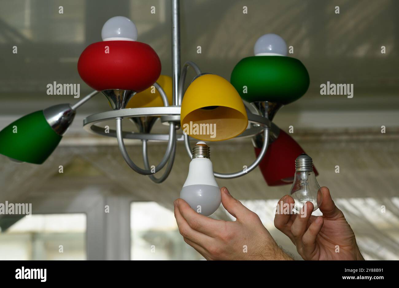 replacing an incandescent light bulb with an energy efficient LED lamp ...