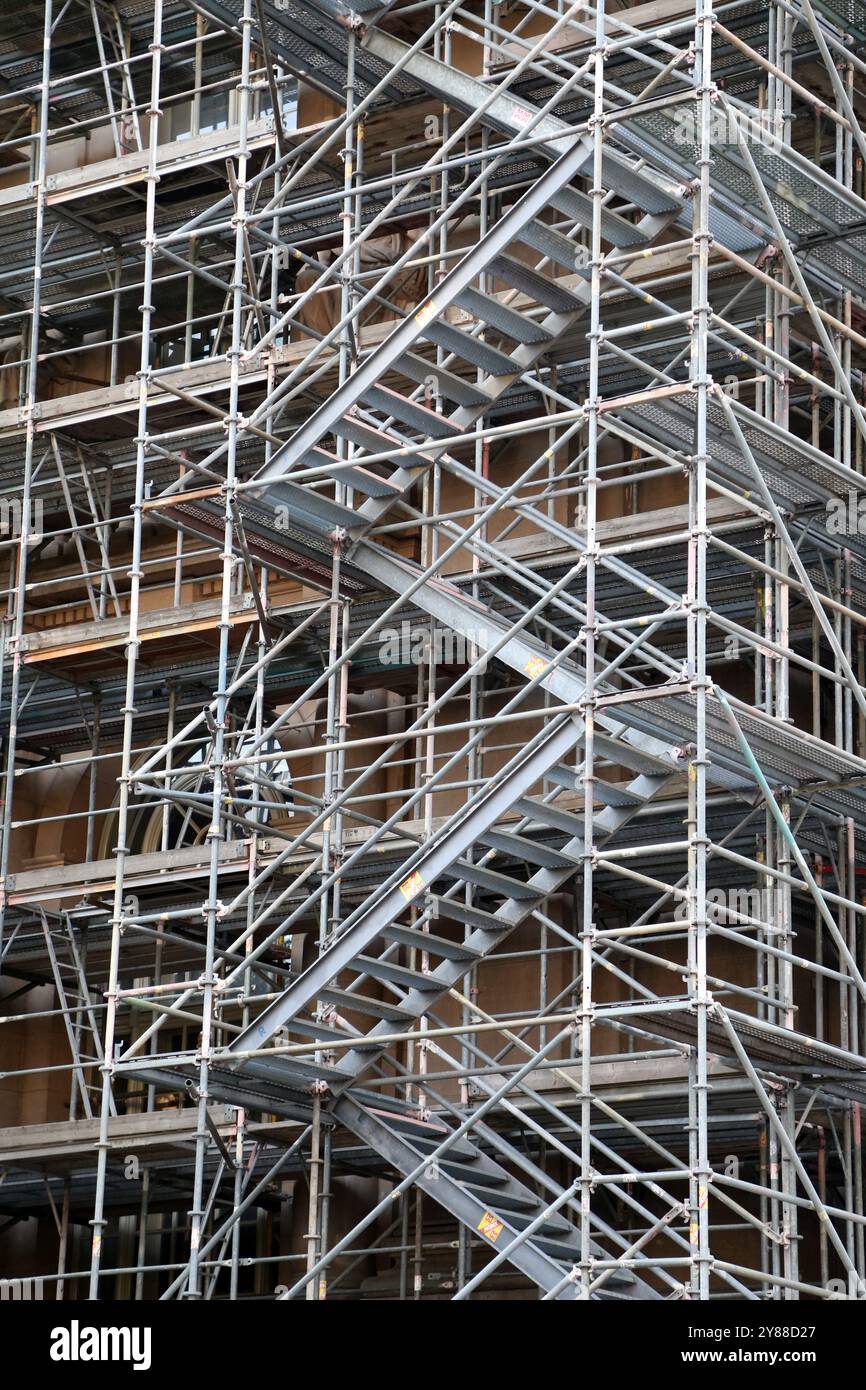 Sturdy steel staircase winds through a complex grid of scaffolding ...