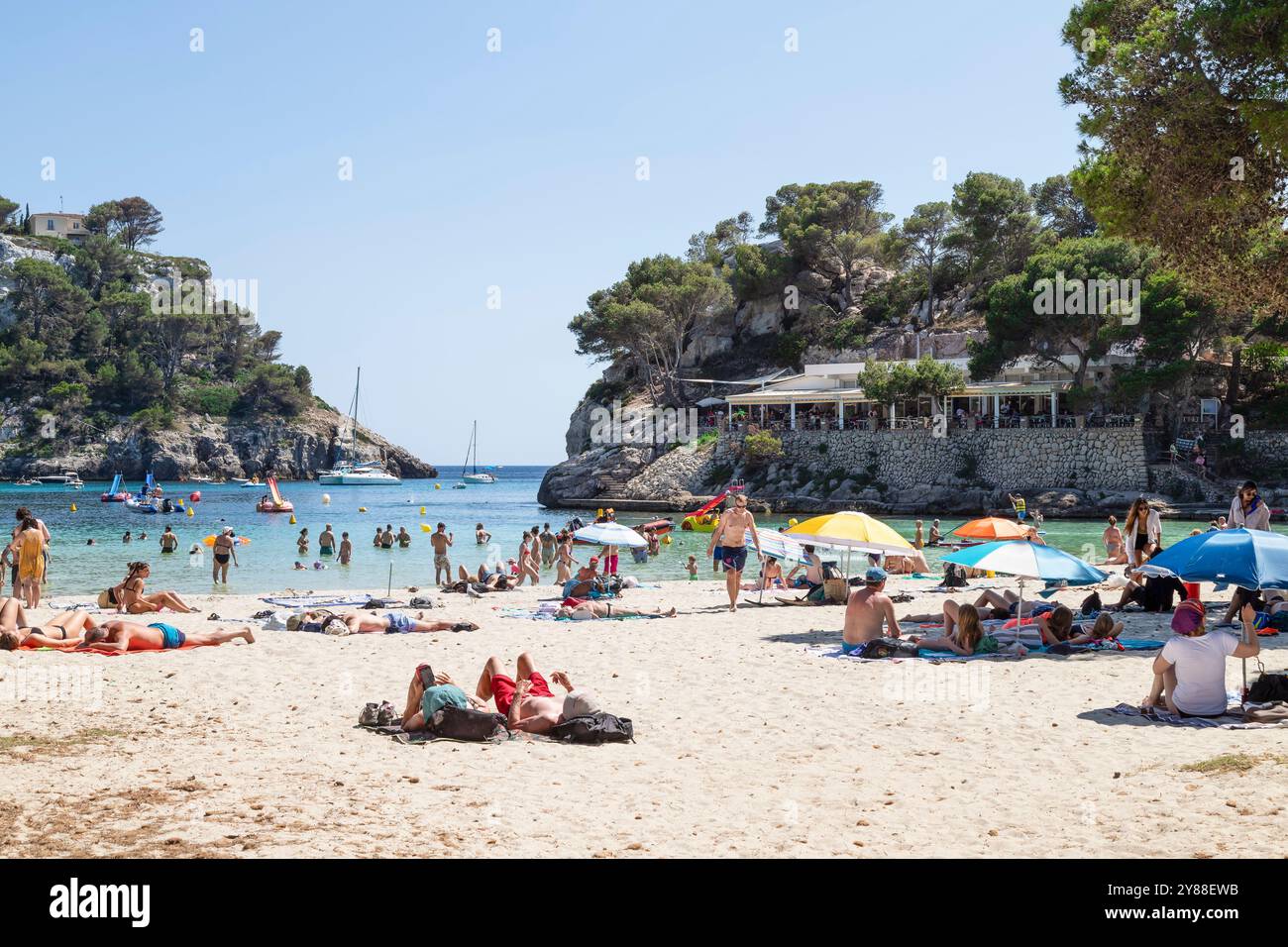 People enjoy the beach at Cala Galdana on the Spanish island of Menorca ...