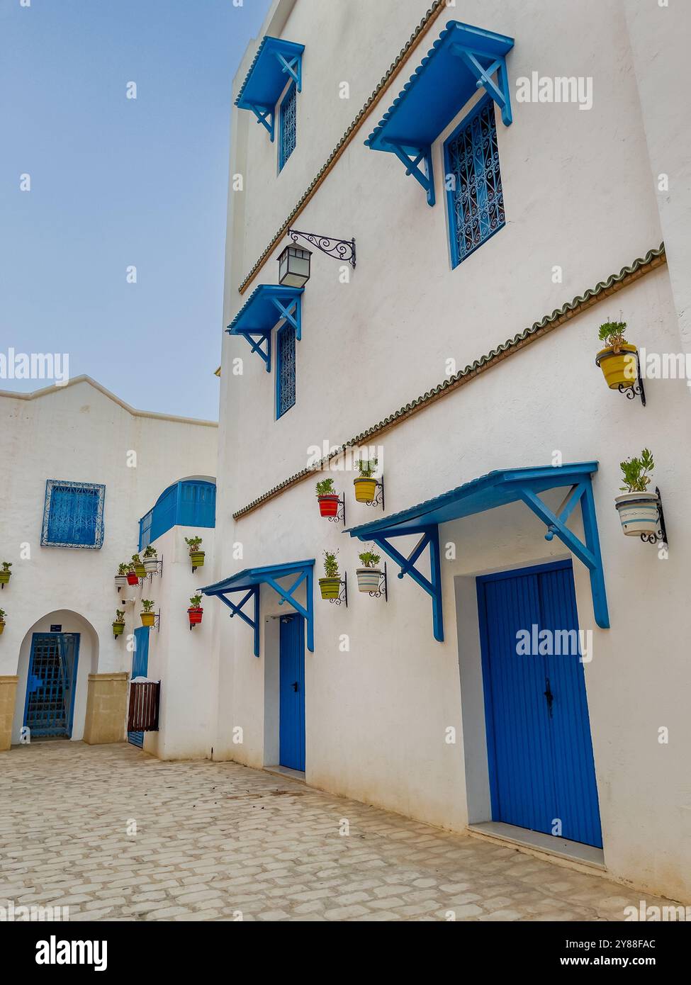 Traditional Tunisian house with blue windows in tiny alley Stock Photo ...