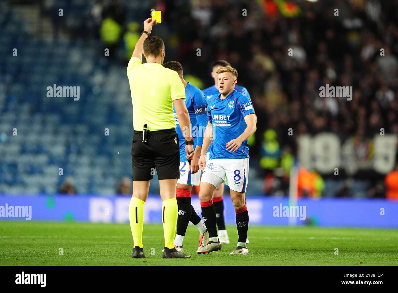 Rangers' Connor Barron (right) is shown a yellow card by match referee ...