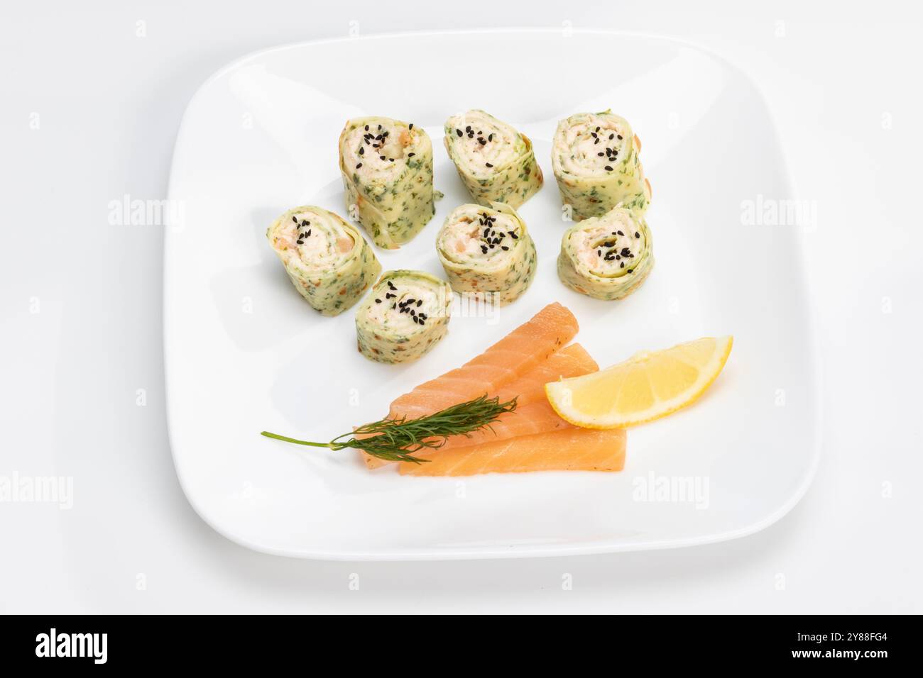 bite sized slices of stuffed crepe, with sliced salmon and a lemon ...