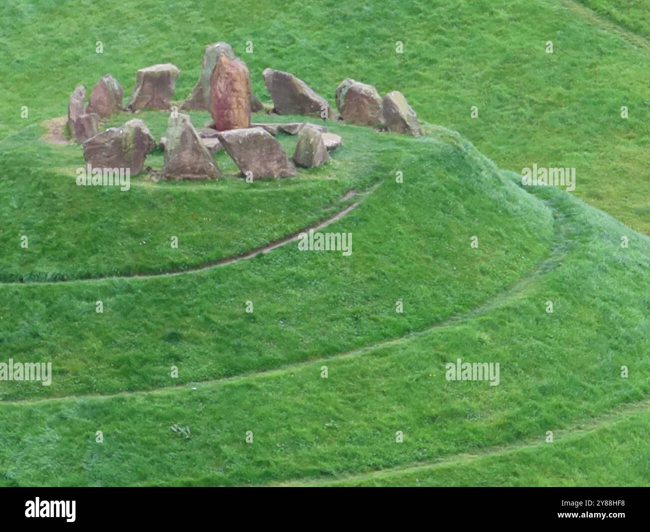 Huge boulders atop one of the mounds with a spiralling path ...