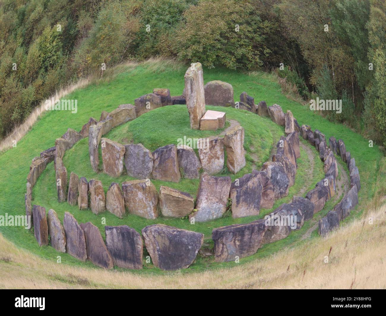 Crawick Multiverse: a corkscrew path between giant boulders on a mound ...
