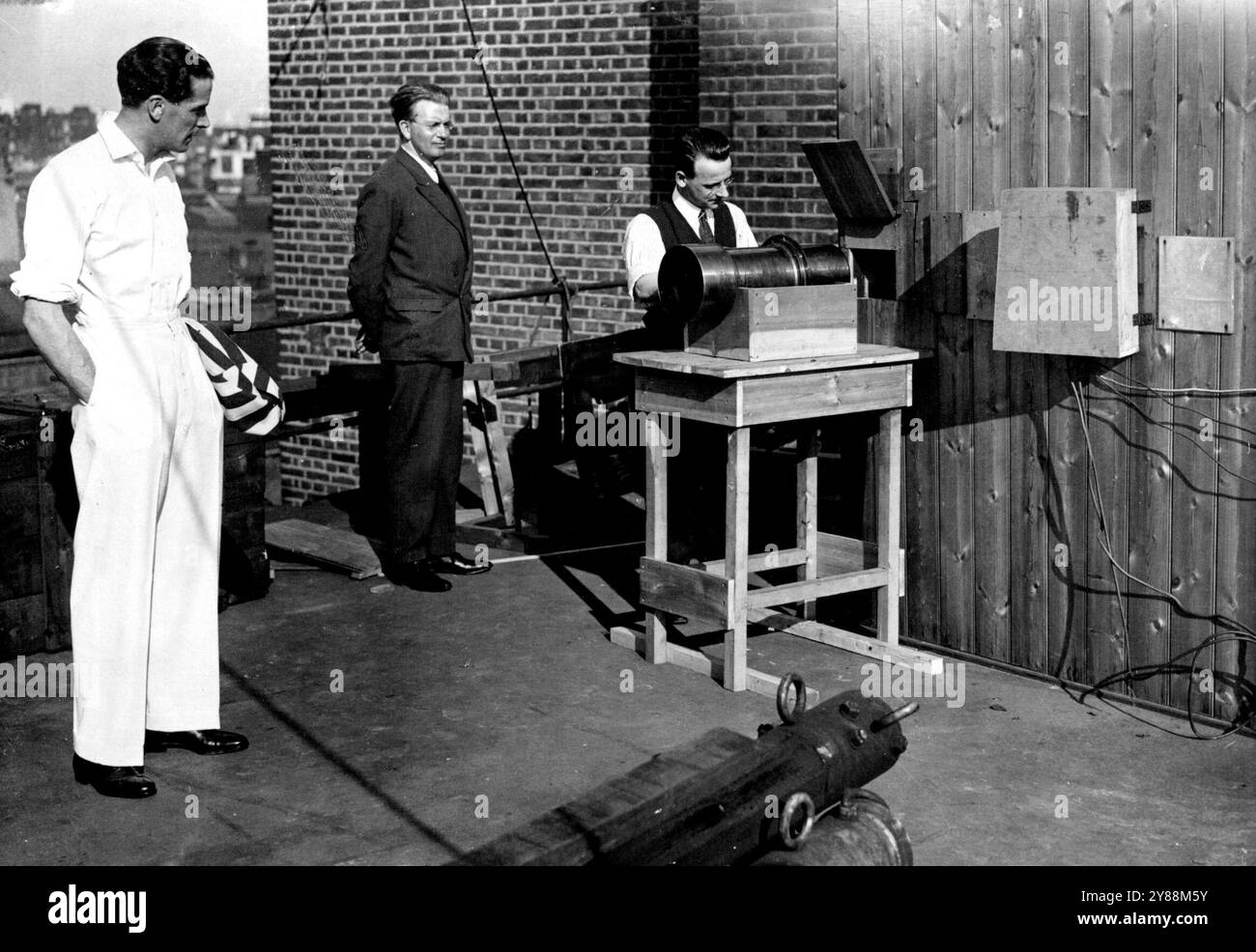 John Logie Baird and Jack Buchanan, the actor, watch whilst an ...