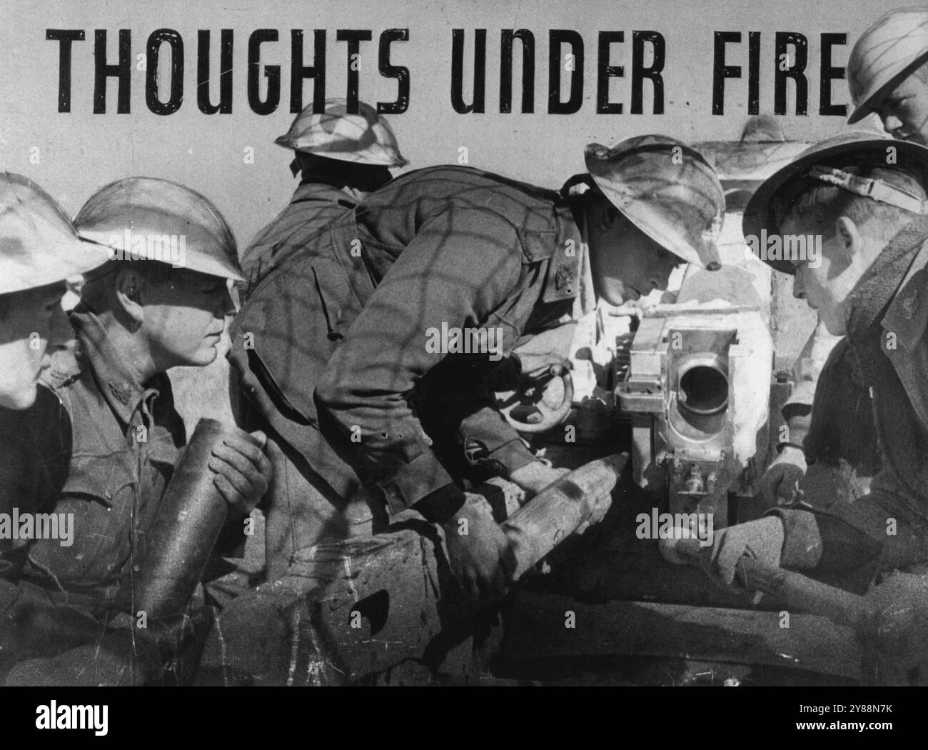 Australian artillerymen in a camouflaged emplace harassing ***** enemy positions at Bardia, and ...