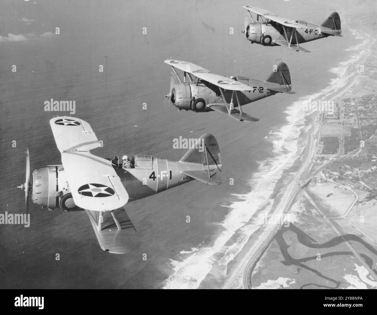 Over The Coastline -- Three Grumman fighting pursuit planes of the U.S ...