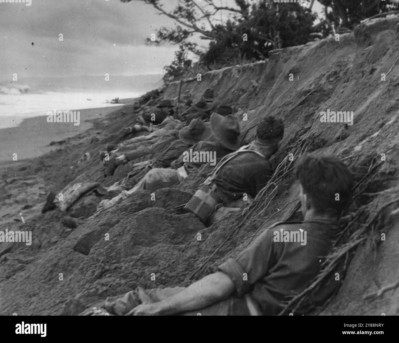 Australian troops moving along the northern New Guinea coast take cover ...