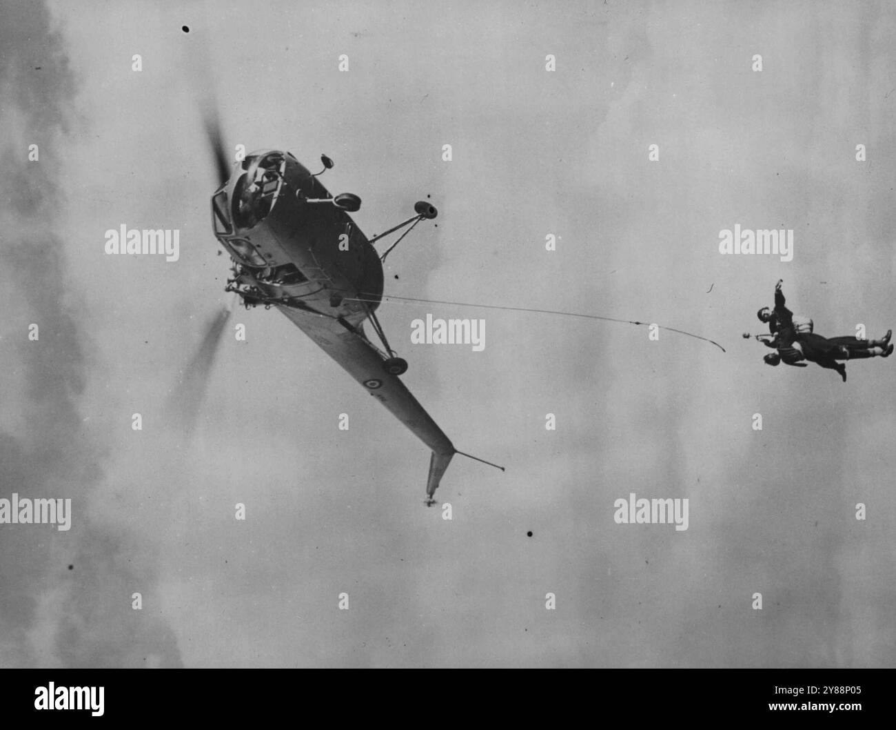 Rescue helicopter man on winch Black and White Stock Photos & Images ...