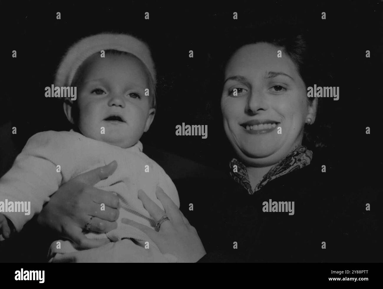 Eleven-Months-Old Clive Starr and his mother look out on the busy scene ...