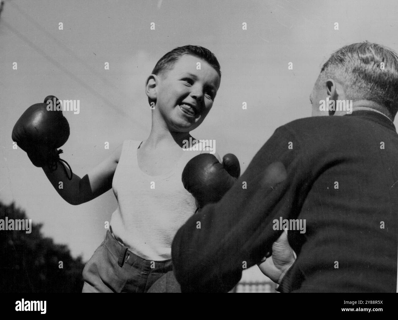 Father and son get together in a morning work-out with boxing gloves ...