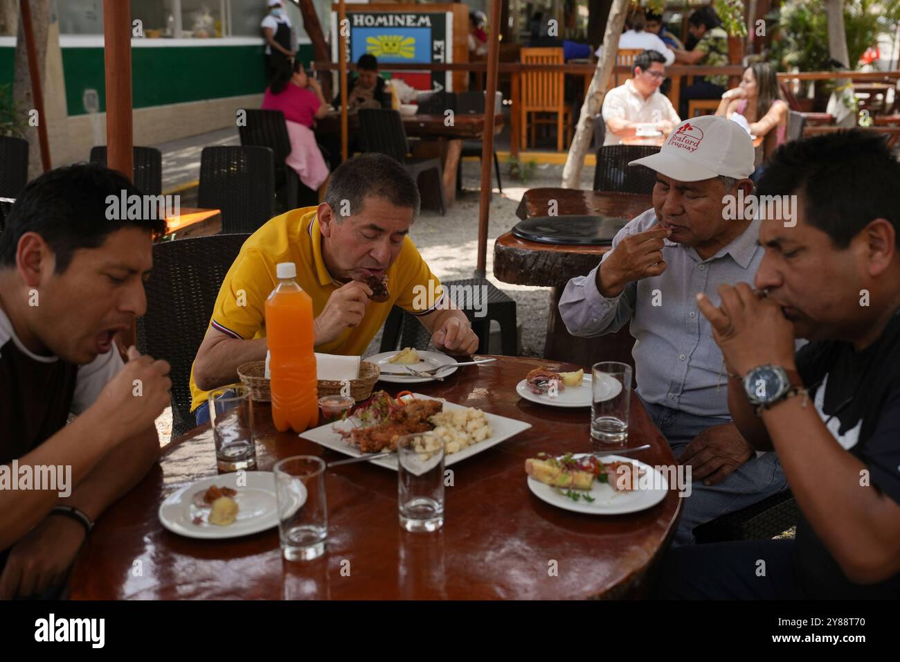 Costumers eat guinea pig at a restaurant in Lima, Peru, Thursday, Oct ...