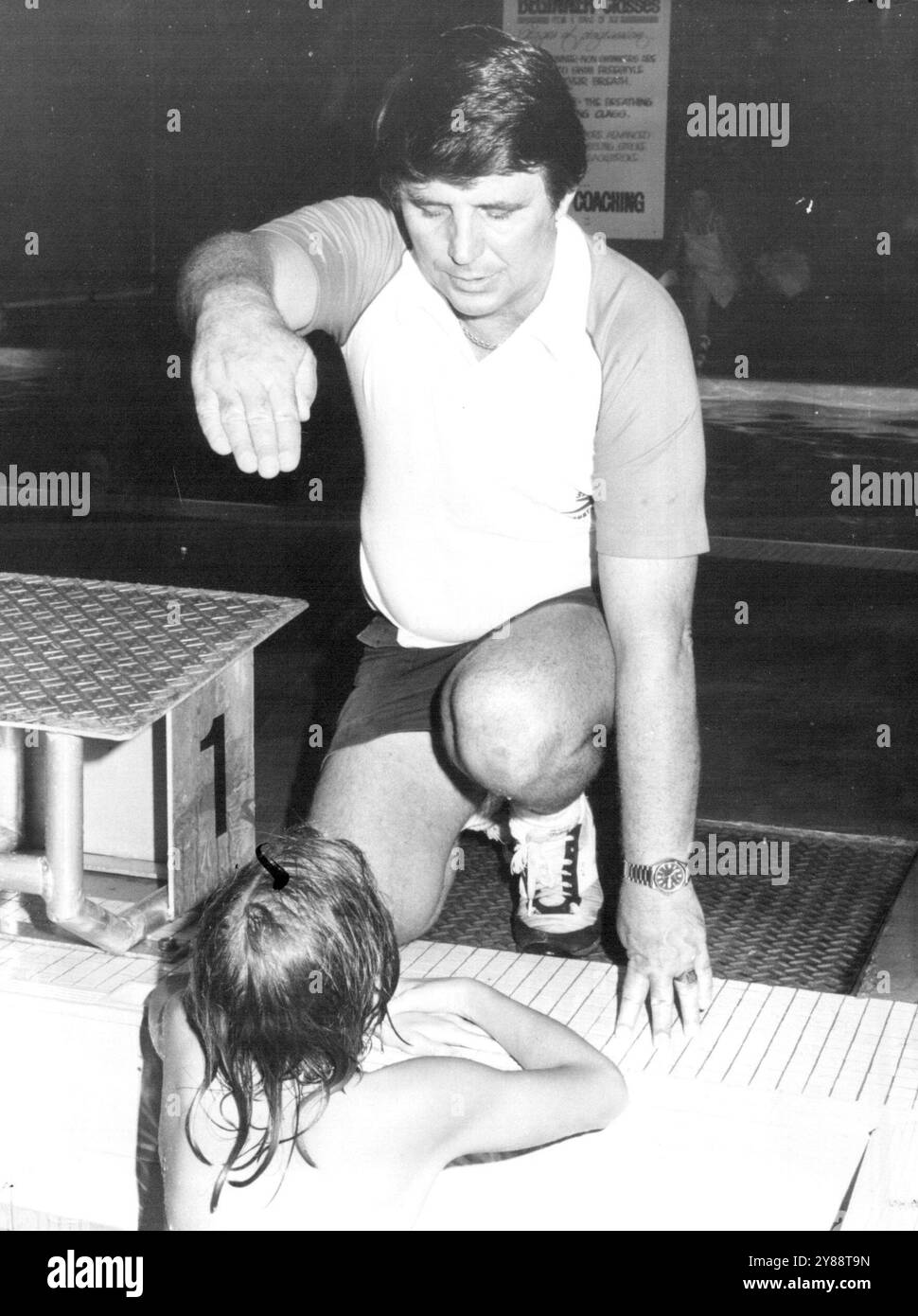 Eric Arnold handing out some hint to a member of the Hunter Swimming ...