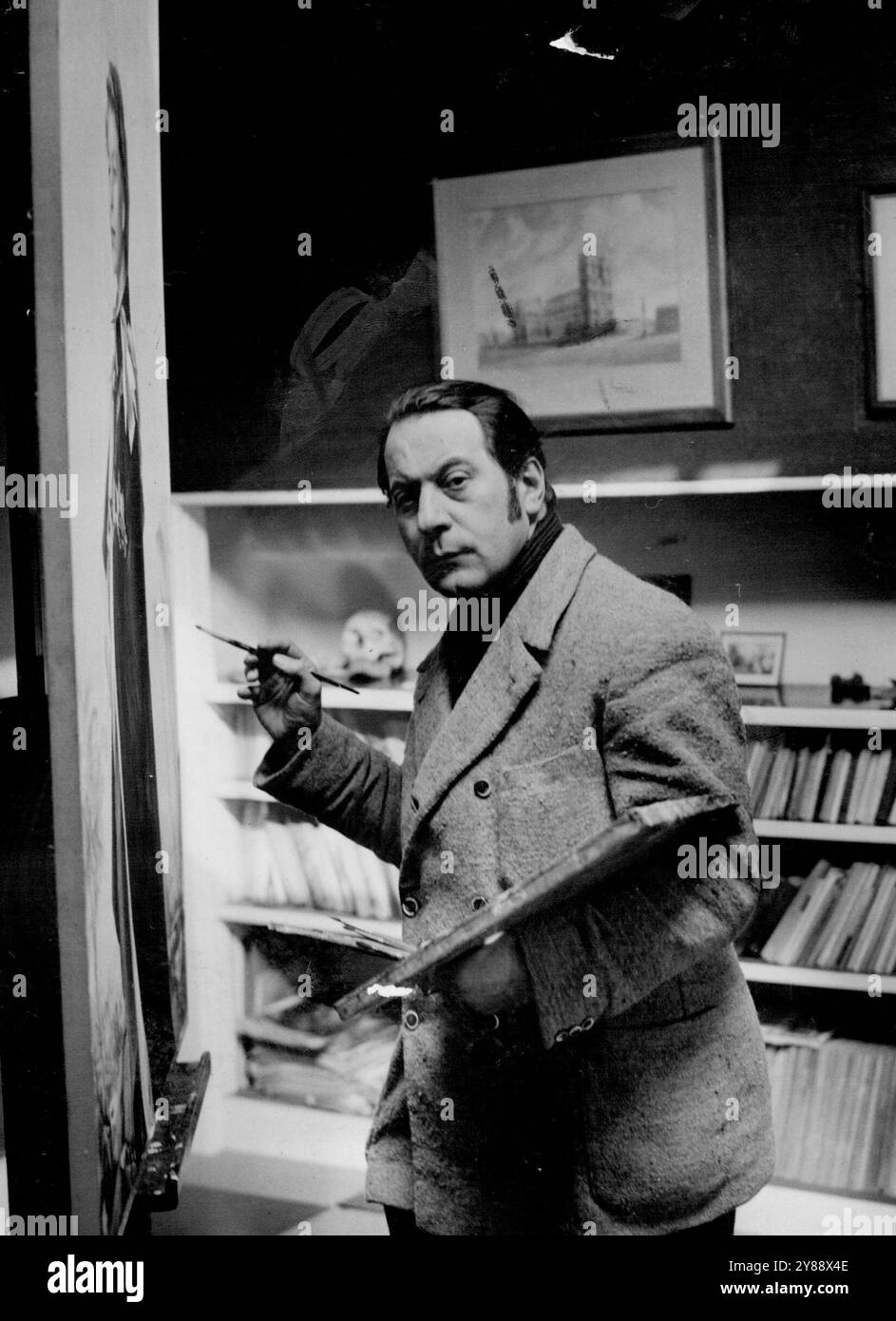 Italian artist Pietro Annigoni putting finishing touches to his ...