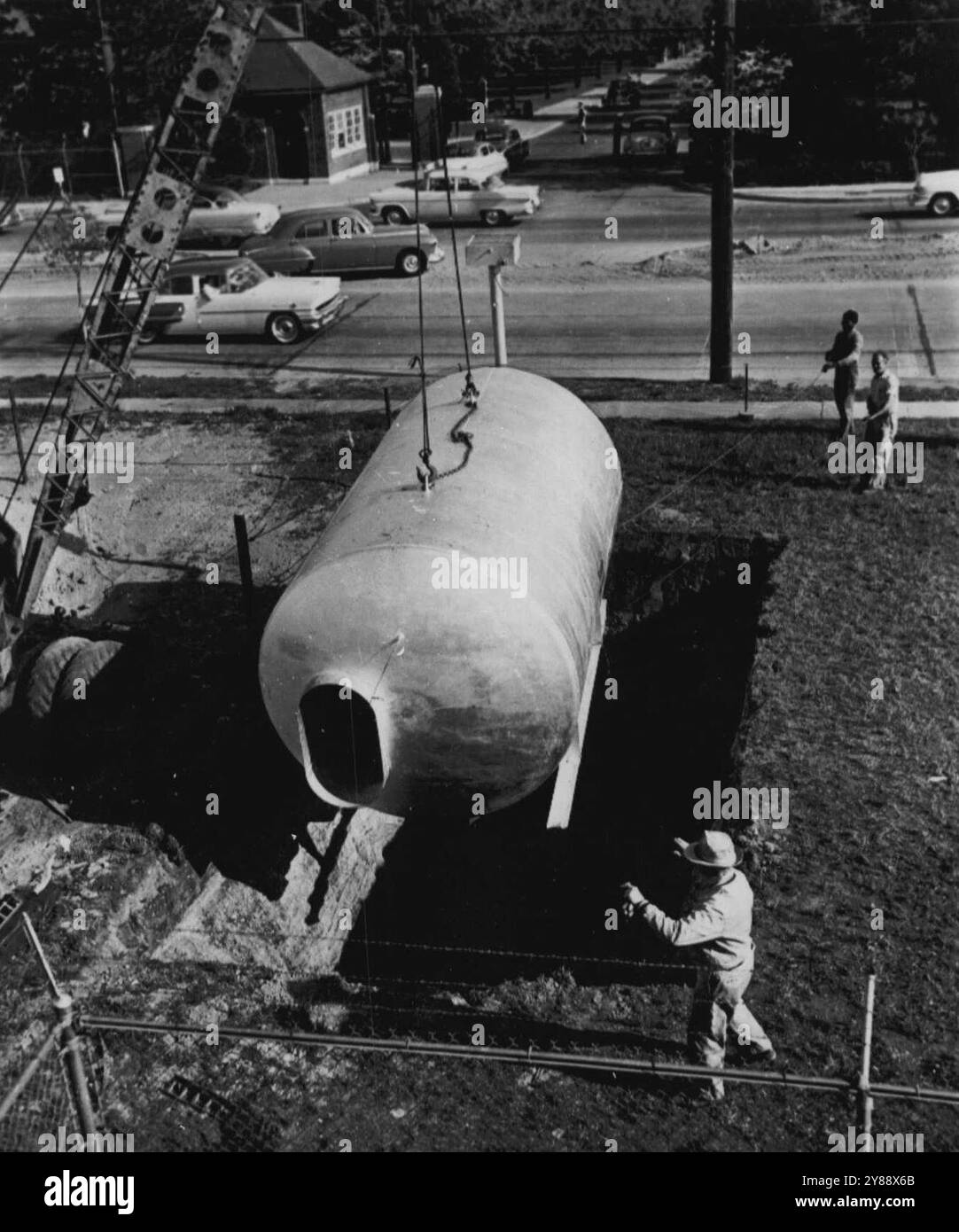 H-Bomb Shelter Lowered Into Position -- A deluxe model H-Bomb shelter ...