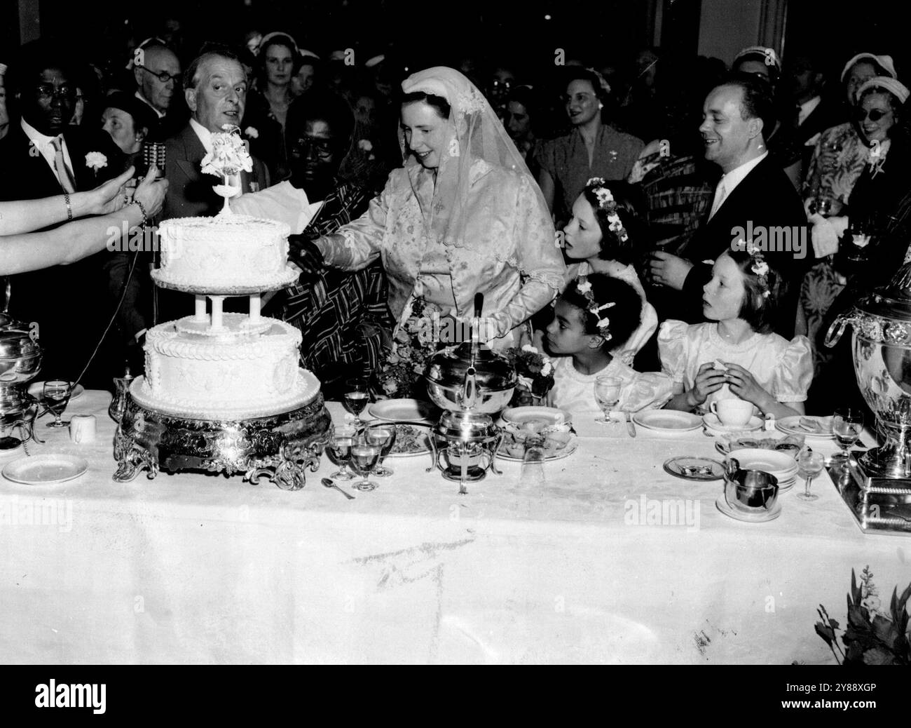 The Wedding Took Place -- The happy bride as she cuts the cake at the ...