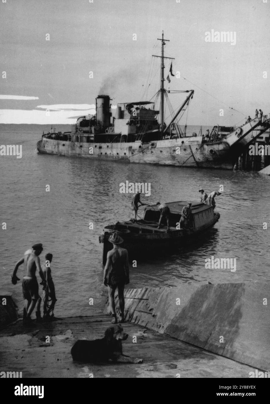The R.A.N. on boom defence duty at an Australian Port.Bringing a line ...