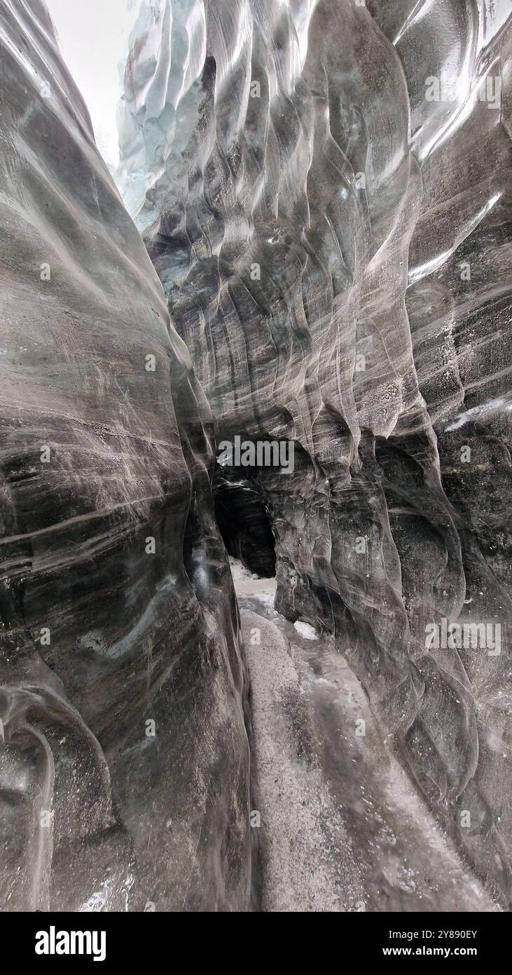 Ice tunnels with visibly shattered glacier rocks at Vatnajokull iceberg ...