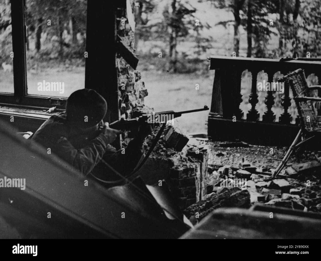 One of the British paratroopers on guard in a ruined house in ...