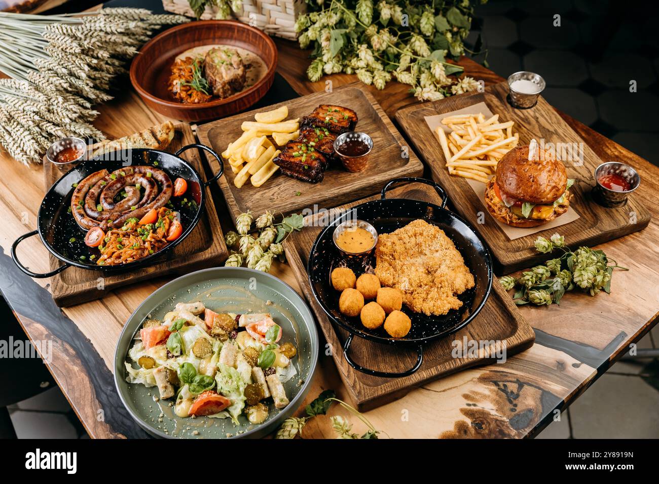 Top view of gourmet food dishes including sausages, ribs, schnitzel ...