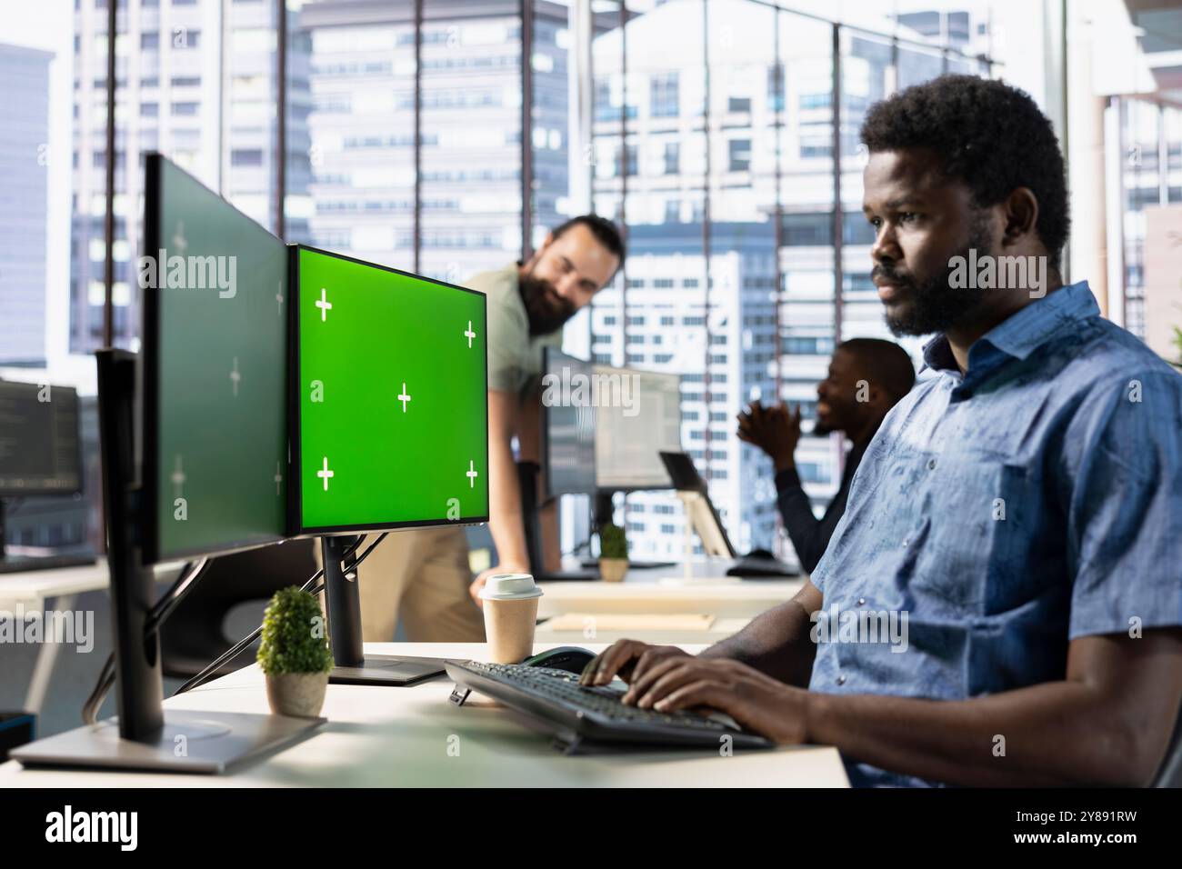 Focused employee analyzing datasets on green screen computer, comparing ...