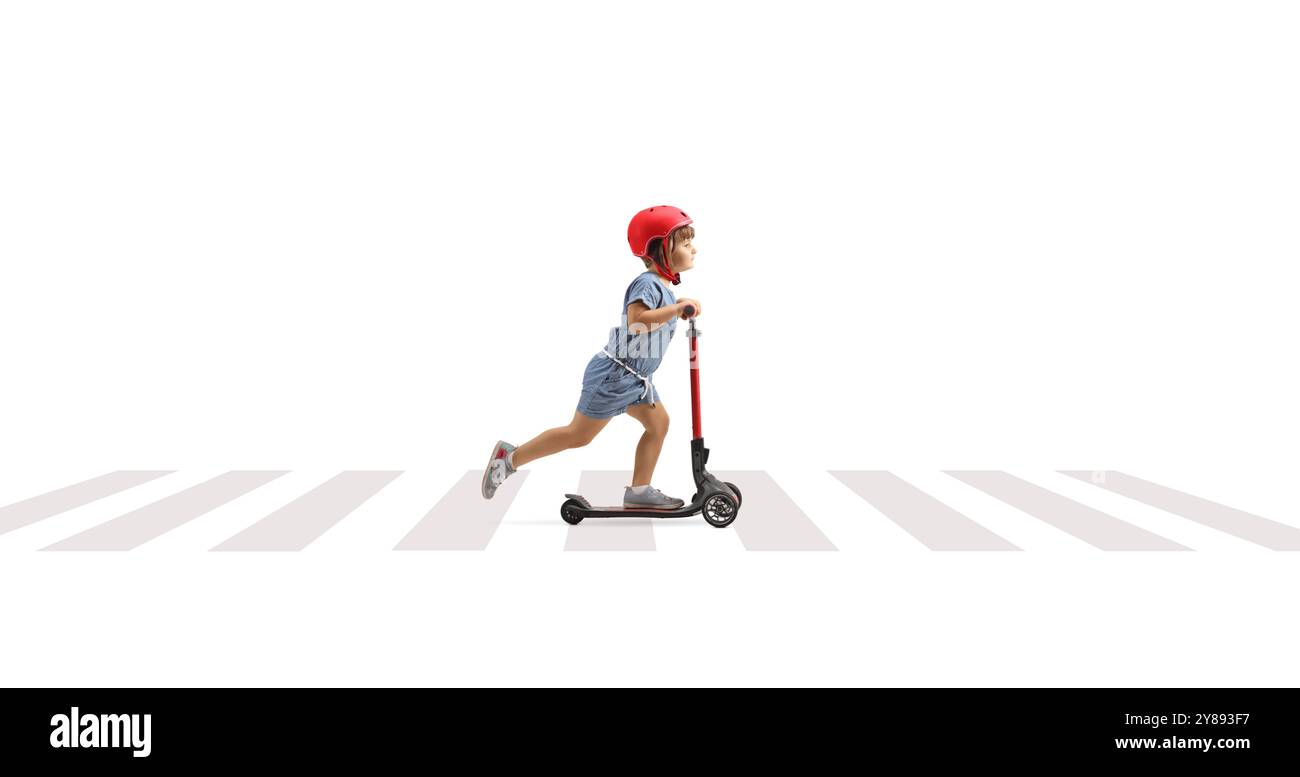 Full length profile shot of a child riding a push scooter with a helmet ...