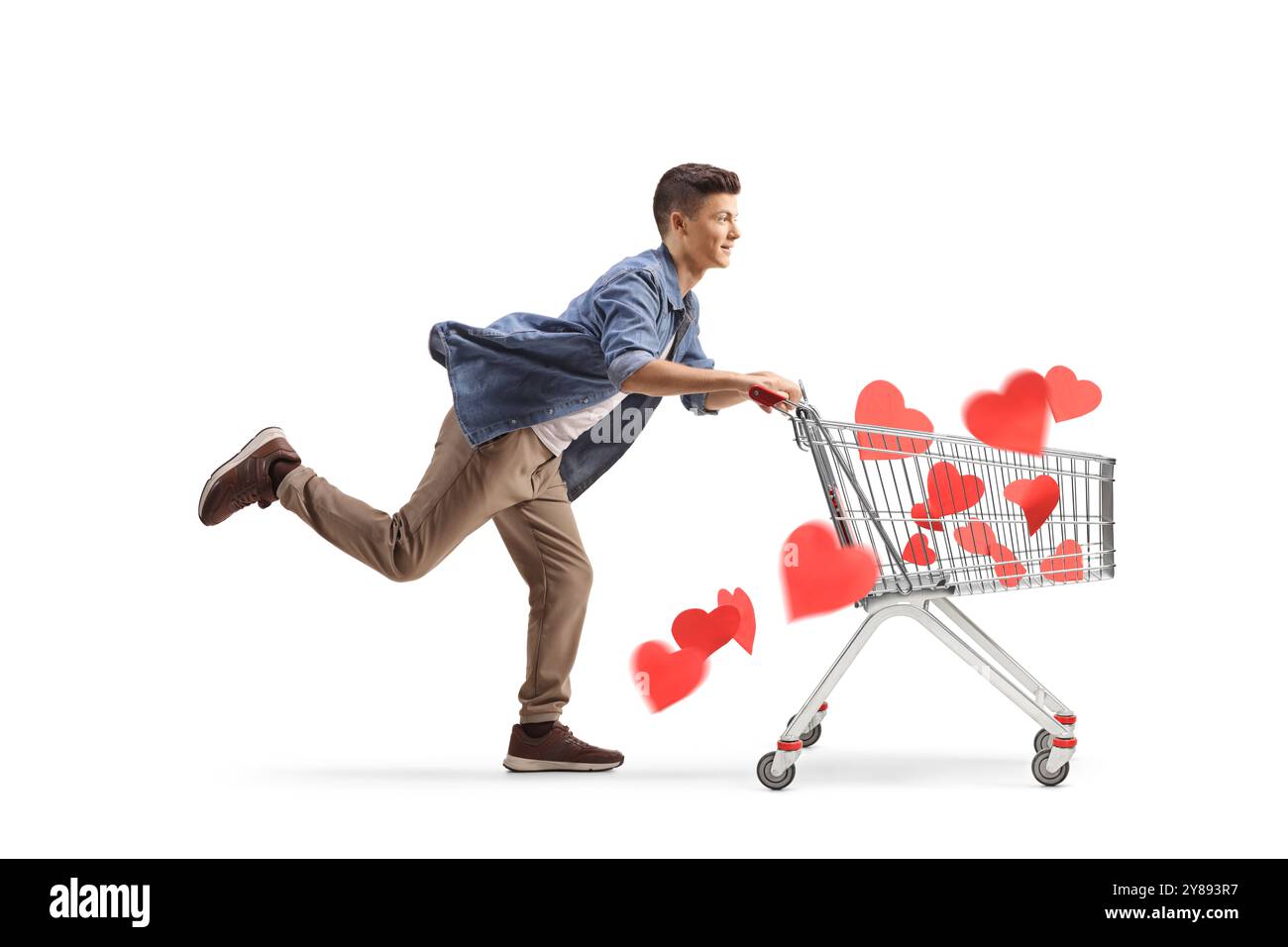 Young man running and pushing a shopping cart full of hearts isolated ...