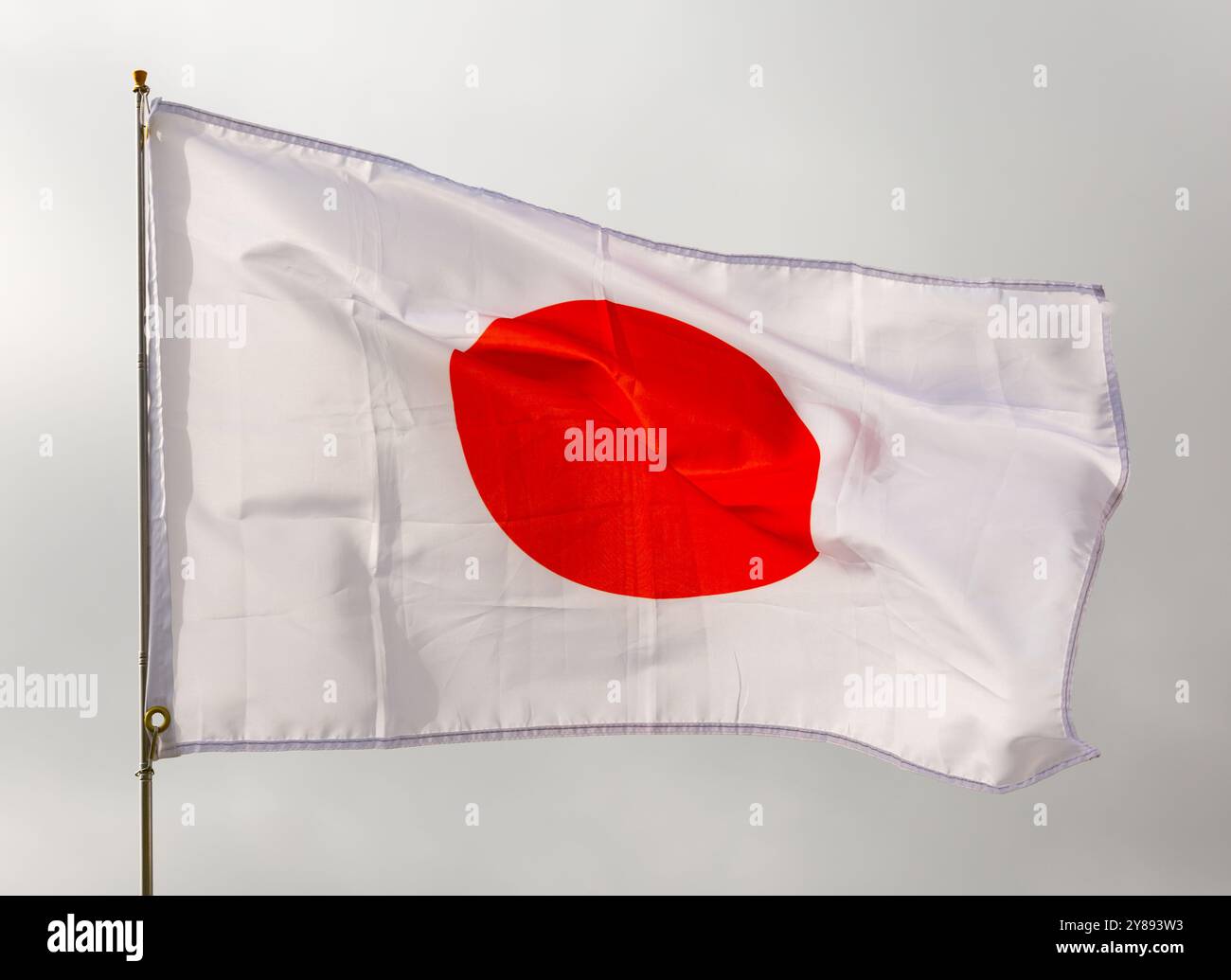 Flag of Japan waving on cloudy sky during daytime Stock Photo - Alamy