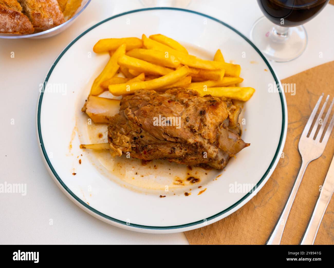 Roasted pork knuckle with vegetable garnish of fried potatoes Stock ...