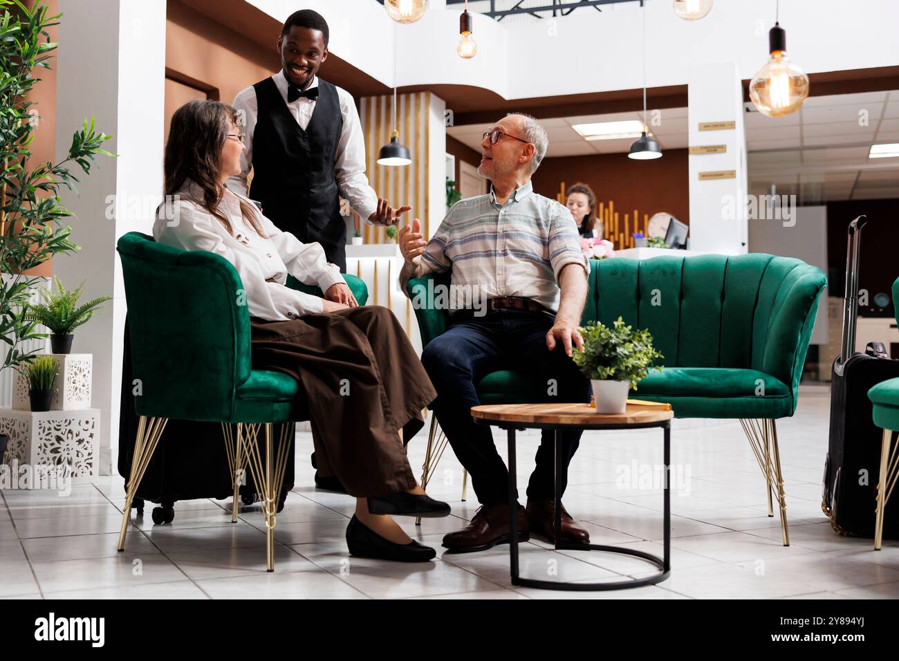 Guests interacting staff hotel reception hi-res stock photography and ...