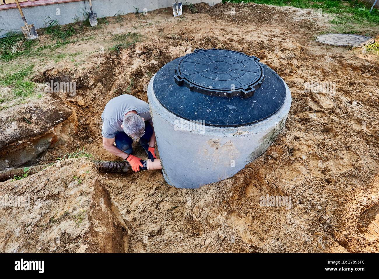Engineer connects flexible perforated pipe placed in an absorbent ...