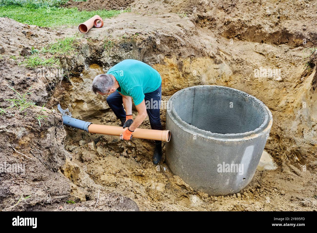 Installation of inlet pipe to concrete ring. Septic tank is autonomous ...