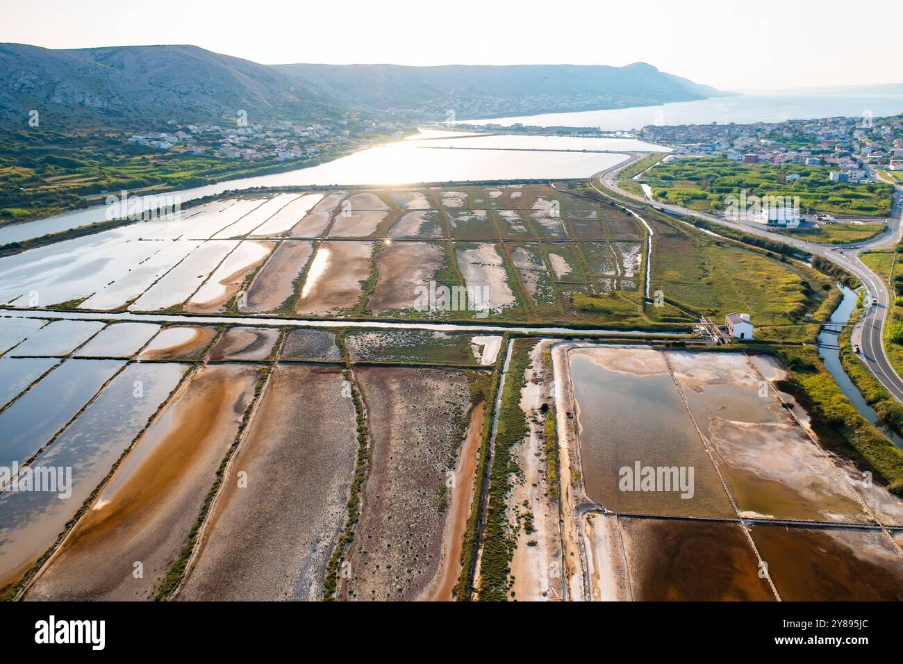 Salt pans are actively harvesting seawater to produce salt in a coastal ...