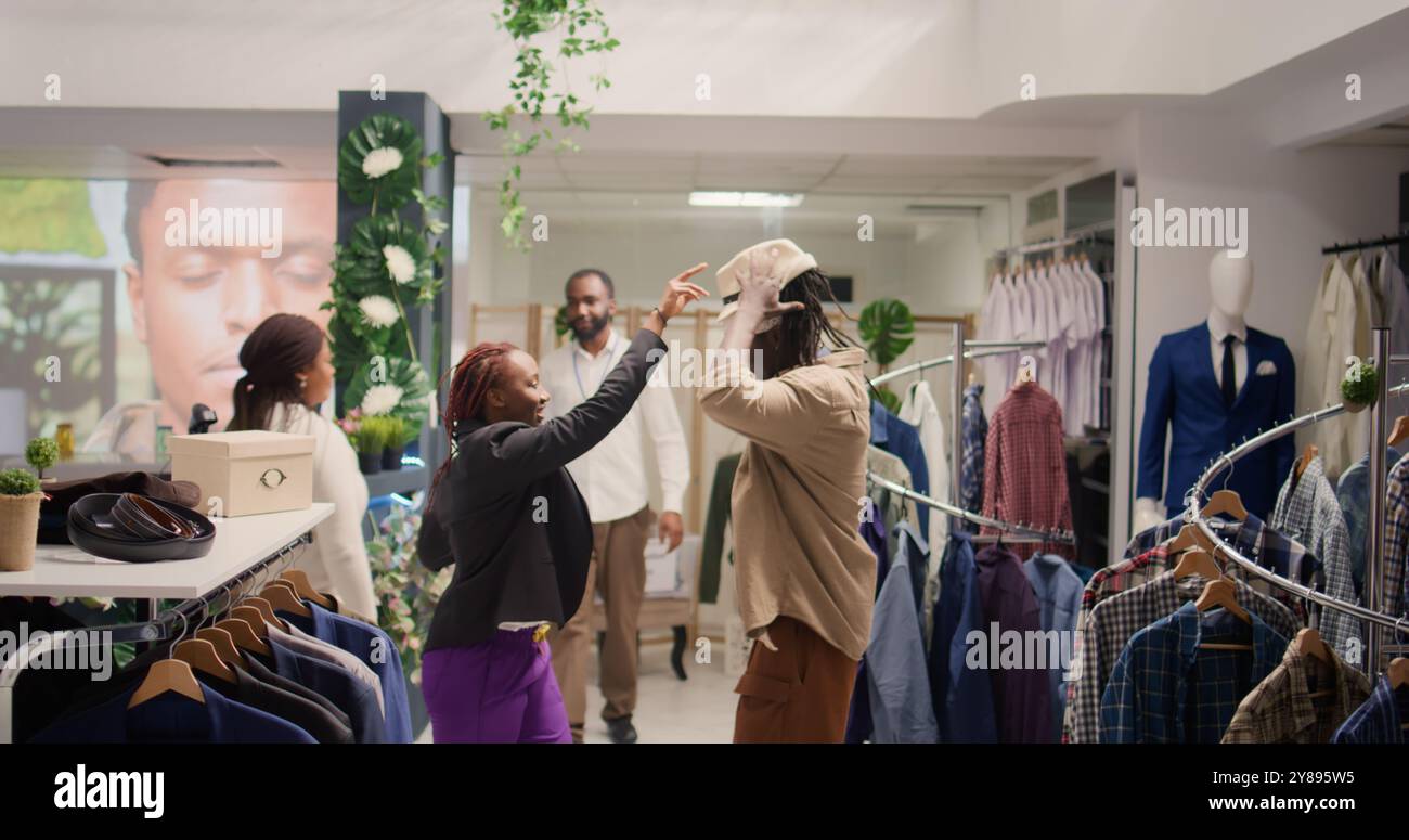 Customers in clothing store during promotional season, having fun ...