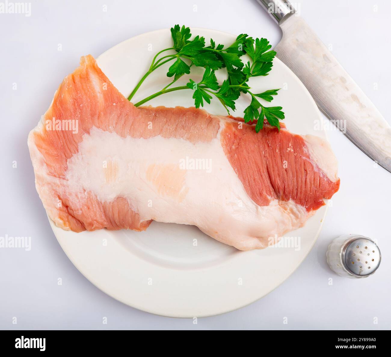 Slice of raw pork chops (Secreto de cerdo) on plate Stock Photo - Alamy