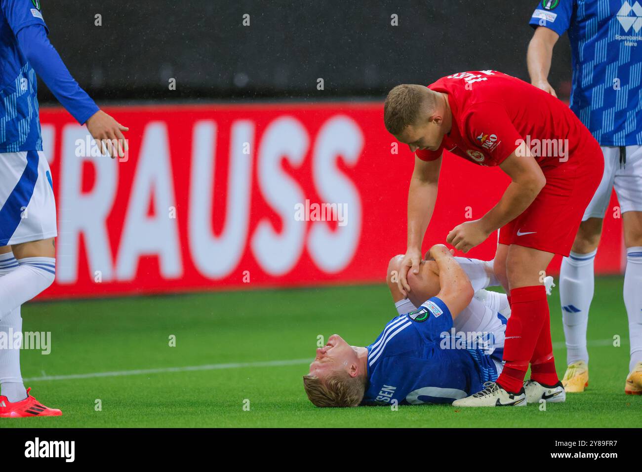 Molde's Kristian Eriksen, bottom, is checked by Lorne's Levi Ives ...