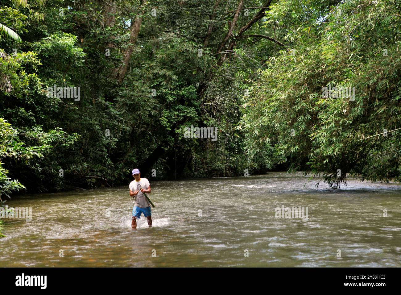 A man walking on shallow water in the river. He is a member of ...