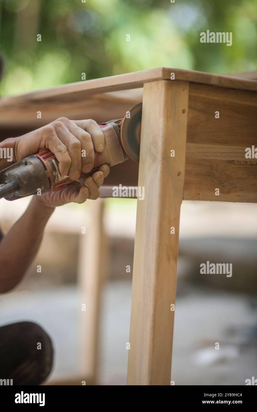 an abrasive machine in a man that smooths the wood surface Stock Photo ...