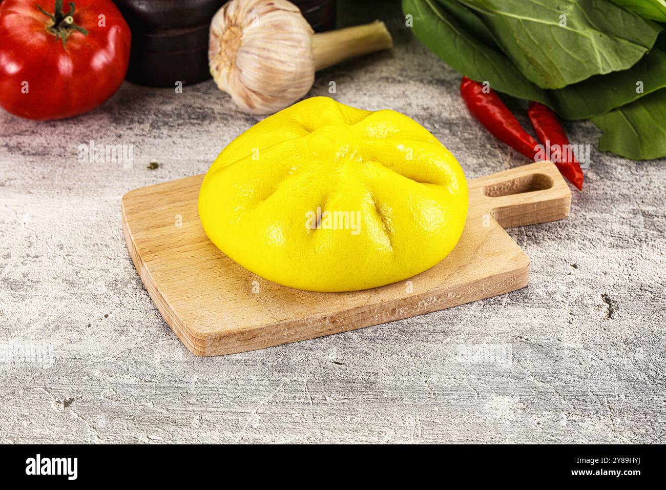 Asian stuffed steamed yellow Bun Bao Stock Photo - Alamy
