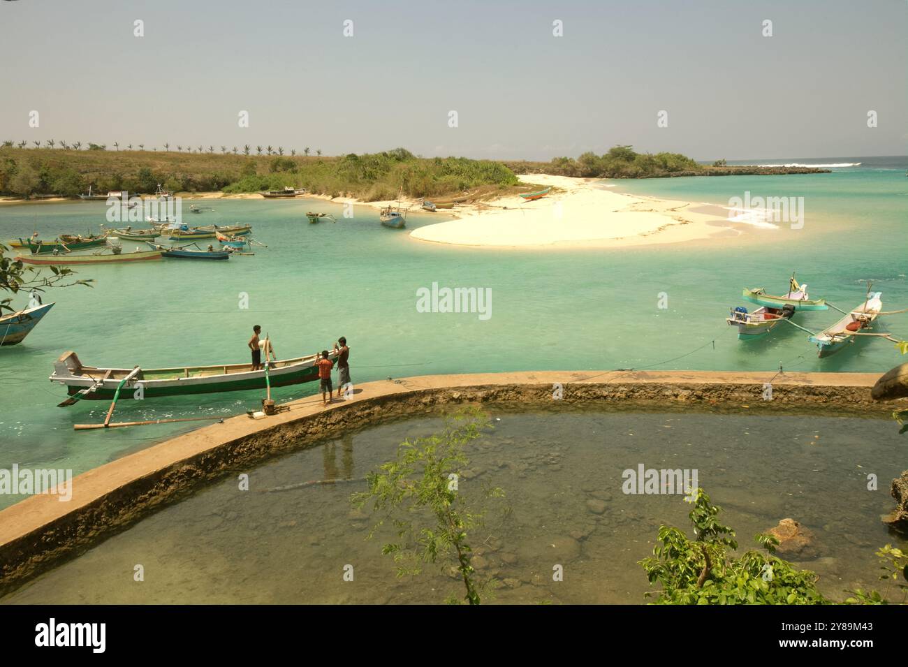 Fishing boats and a concrete pathway on Pero beach in Pero Batang ...