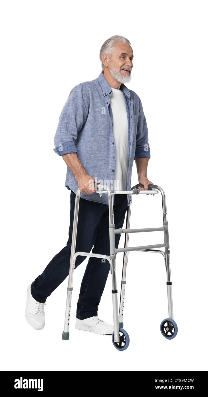 Senior man using walking frame on white background Stock Photo - Alamy