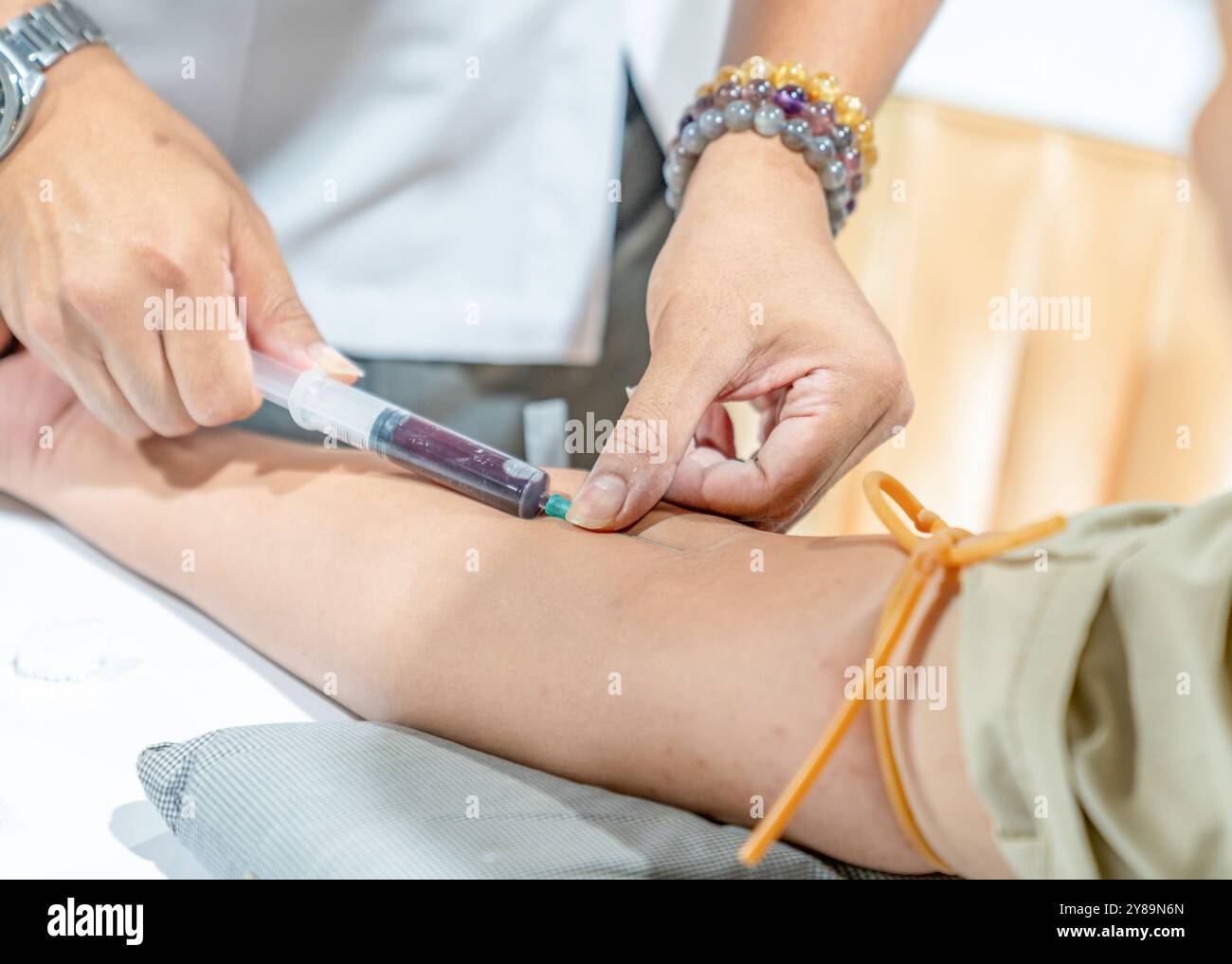 Nurse drawing blood from staff in Annual Health Check-up at company ...