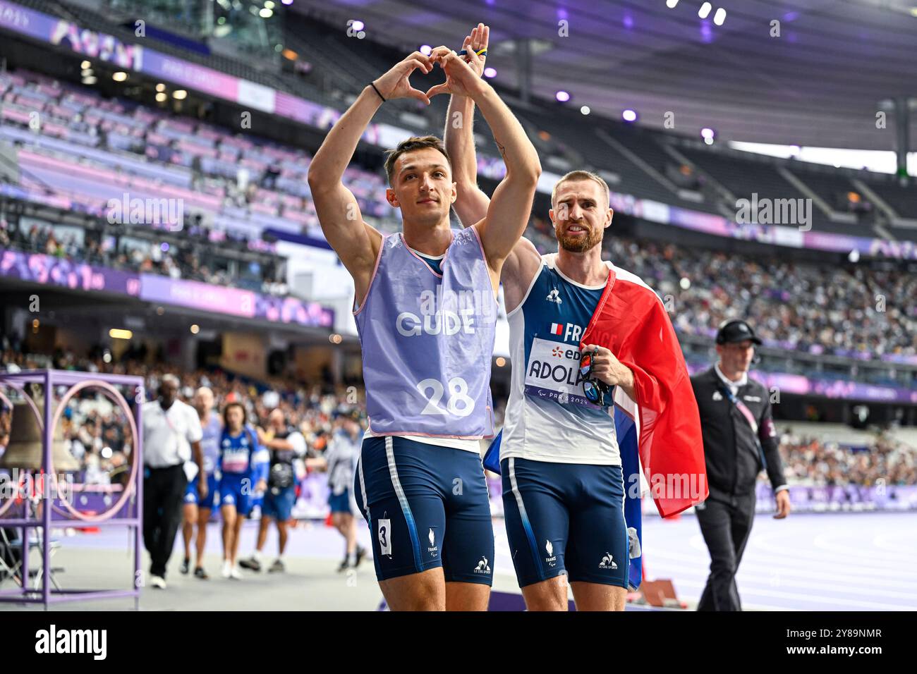 The blind runner Timothée Adolphe and his race guide Charles Renard ...