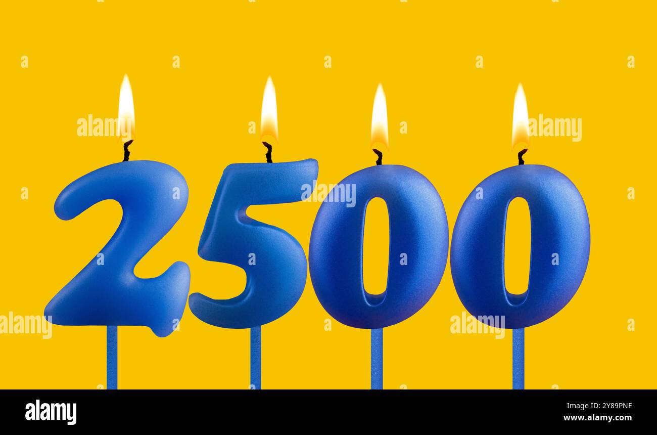 Blue birthday candle on yellow background - Number 2500 Stock Photo - Alamy