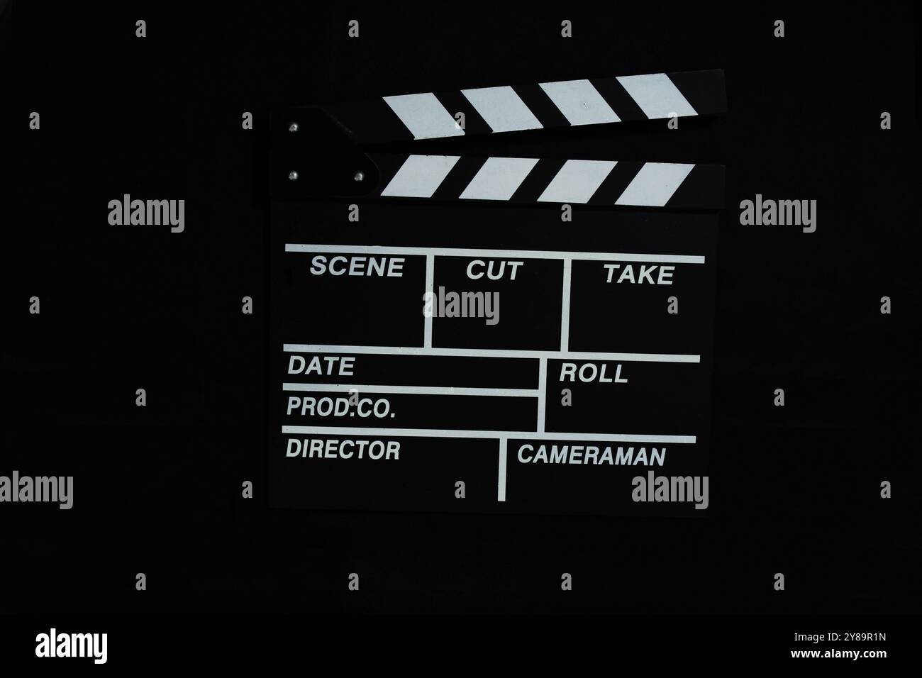 Screenwriter desktop with movie clapper board black background top view ...
