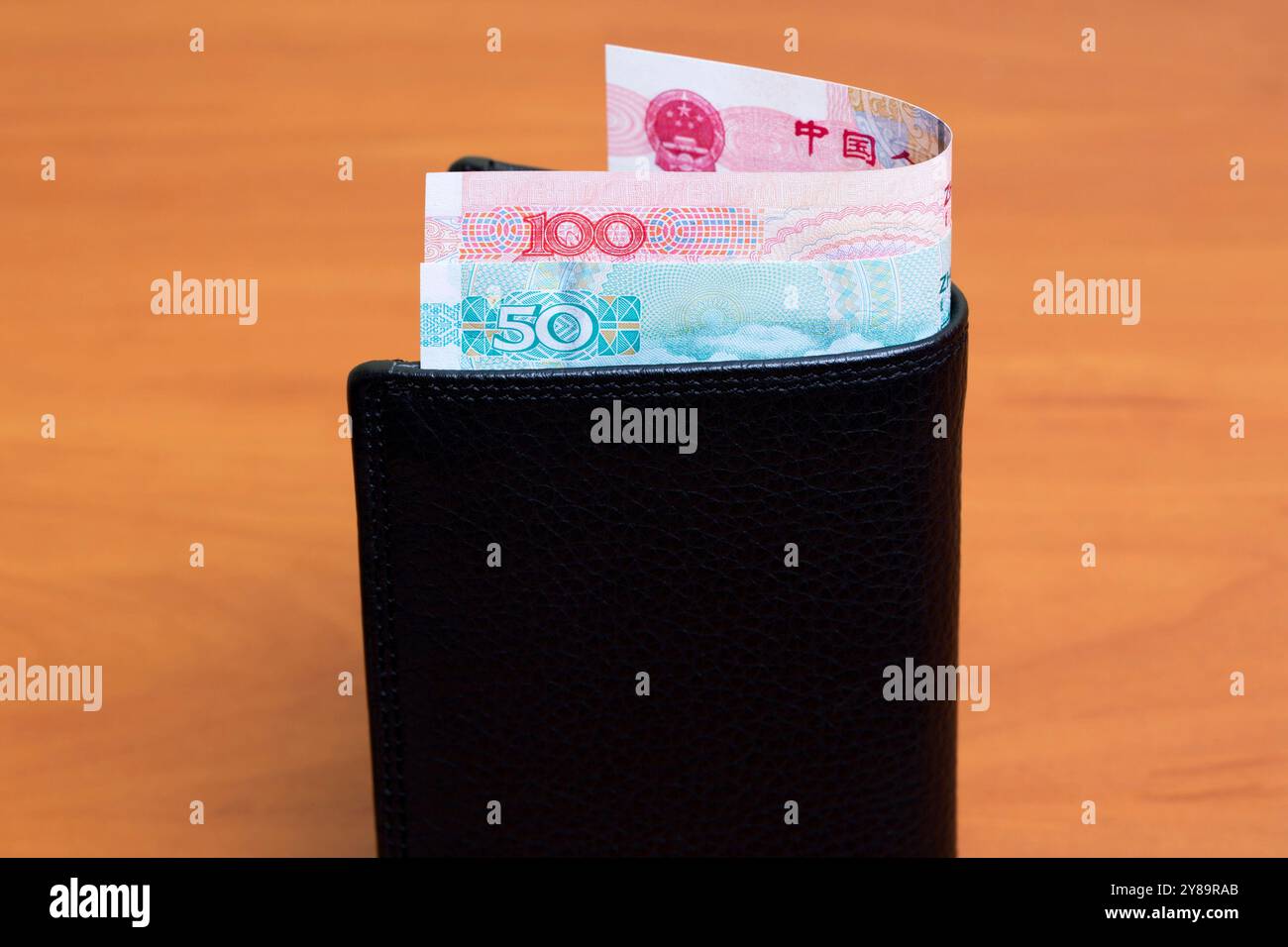 Chinese money - yuan in the black wallet Stock Photo - Alamy