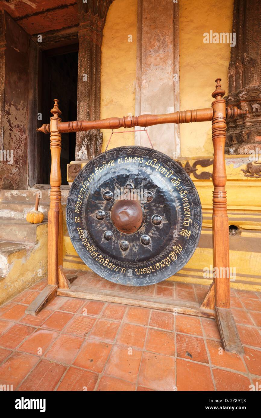 A metal, steel, round gong, hanging outside the temple door. At Wat ...
