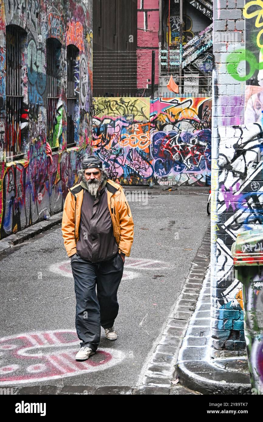 A man walking in Hosier lane, a famous graffiti street in Melbourne ...